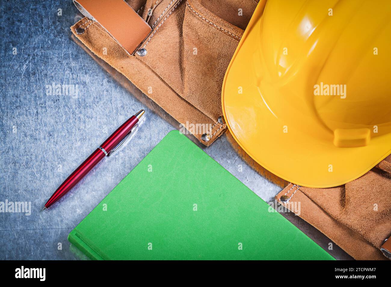 Leather tool belt building helmet notepad pen on metallic background ...