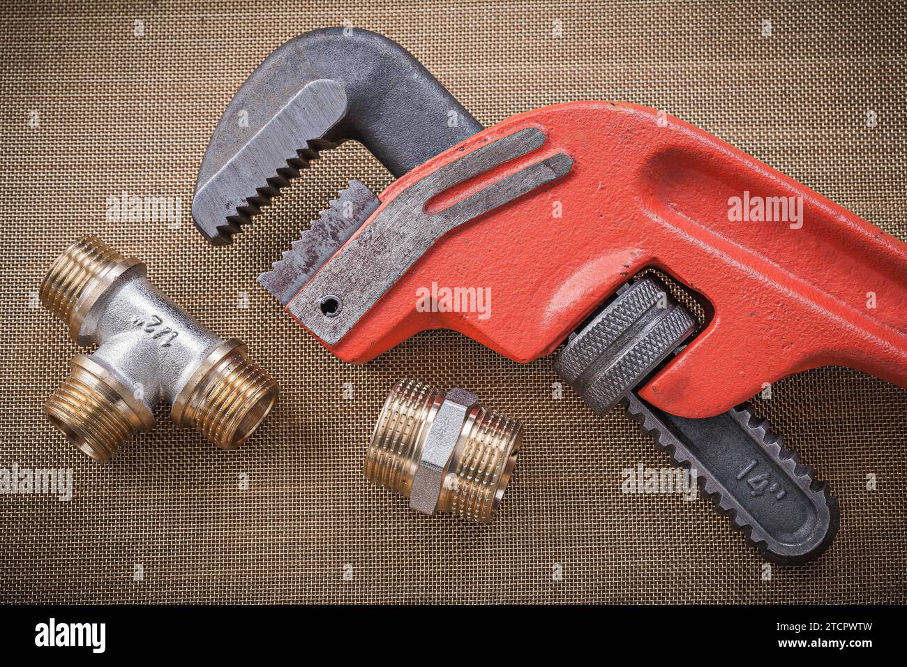 Monkey wrench Brass fittings on mesh filter grille Stock Photo - Alamy