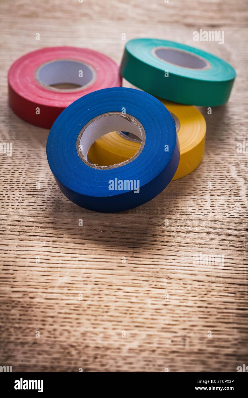 Four rolls of insulating tape on wooden boards Concept Stock Photo - Alamy