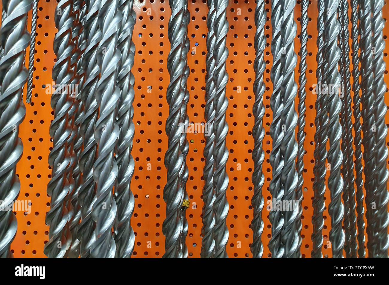 Close up view of a bundle of steel wires, reflecting the light of the ...