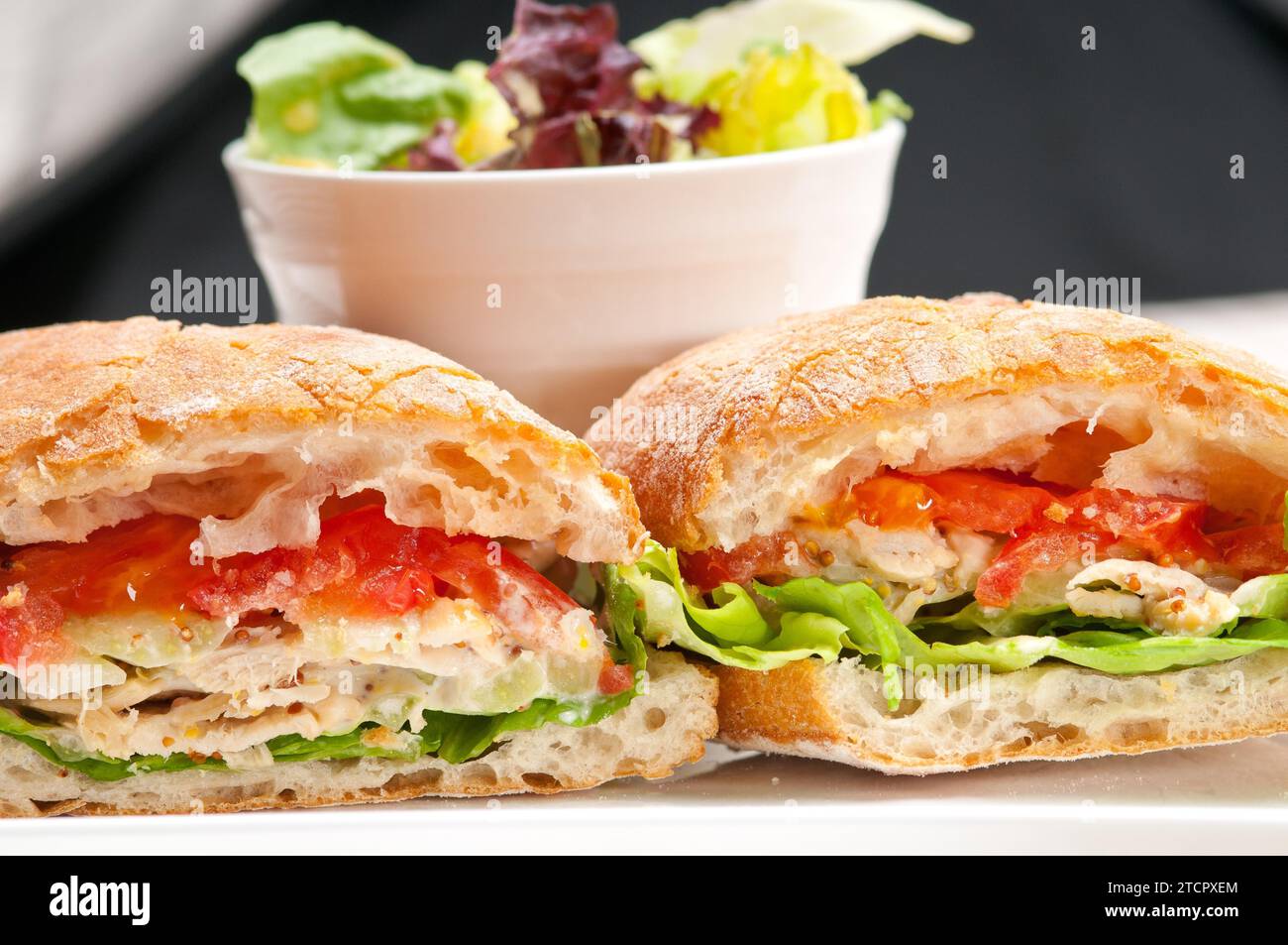 Italian ciabatta panini sandwich with chicken and tomato Stock Photo ...