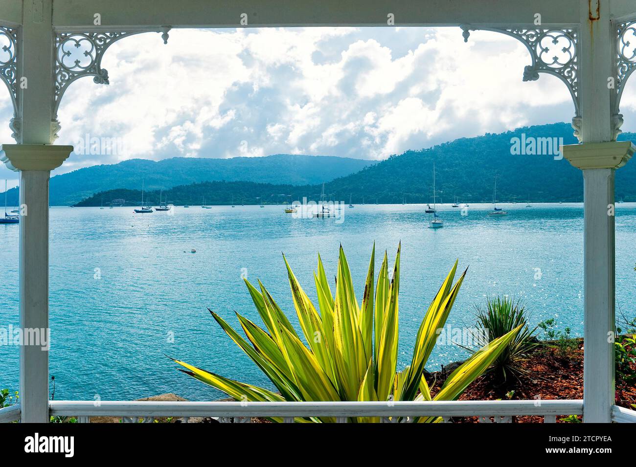 View from the garden pavilion of a hotel to the bay with sailing ships ...