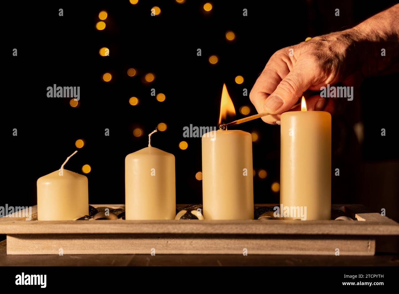 Light the second Advent candle with a match Stock Photo - Alamy