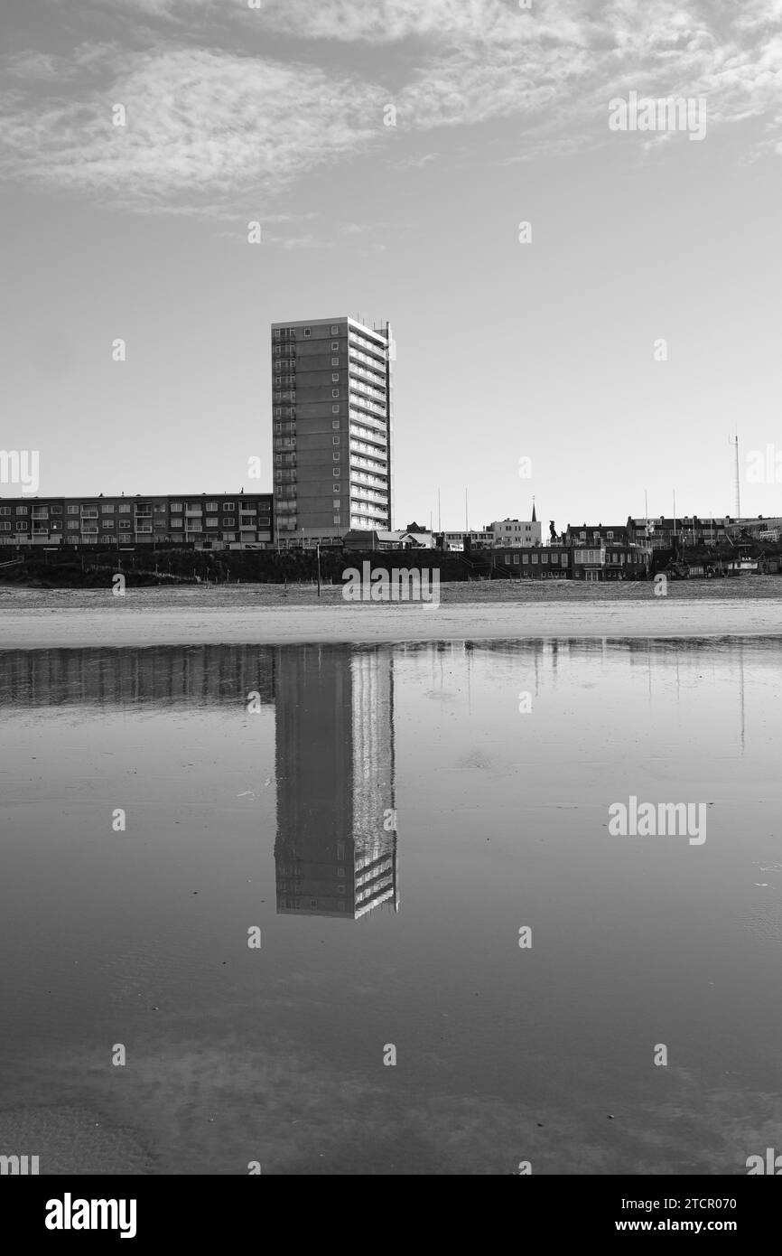 Building on sandy beach, reflection, black and white, North Sea ...