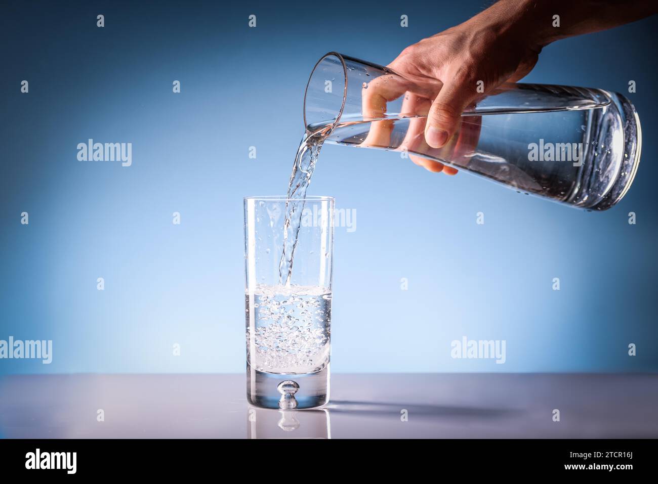 Pouring drinking water from a pitcher into a glass. Clean drinkable ...