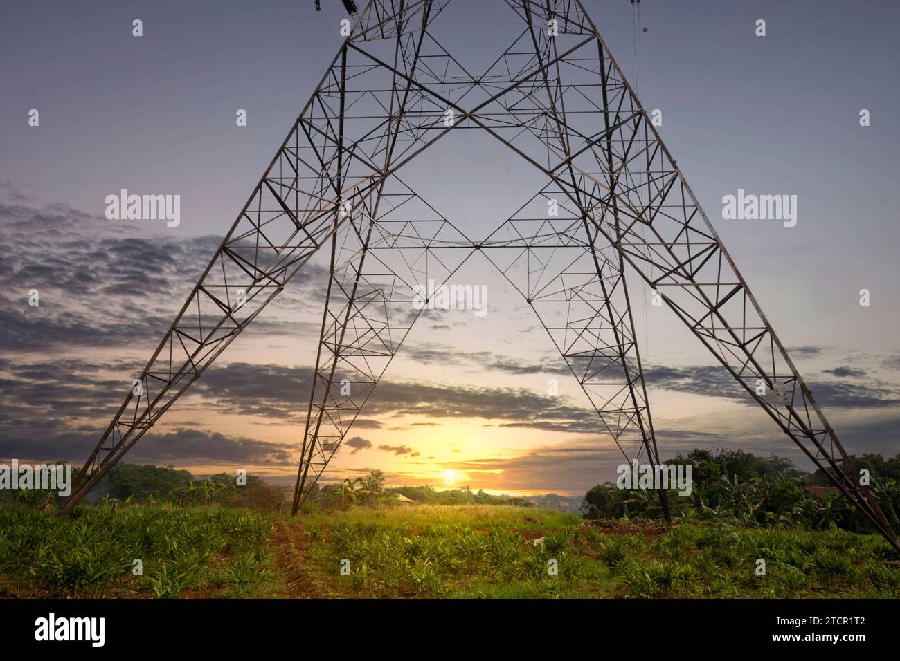 High voltage power lines tower with a sunset scene background Stock ...