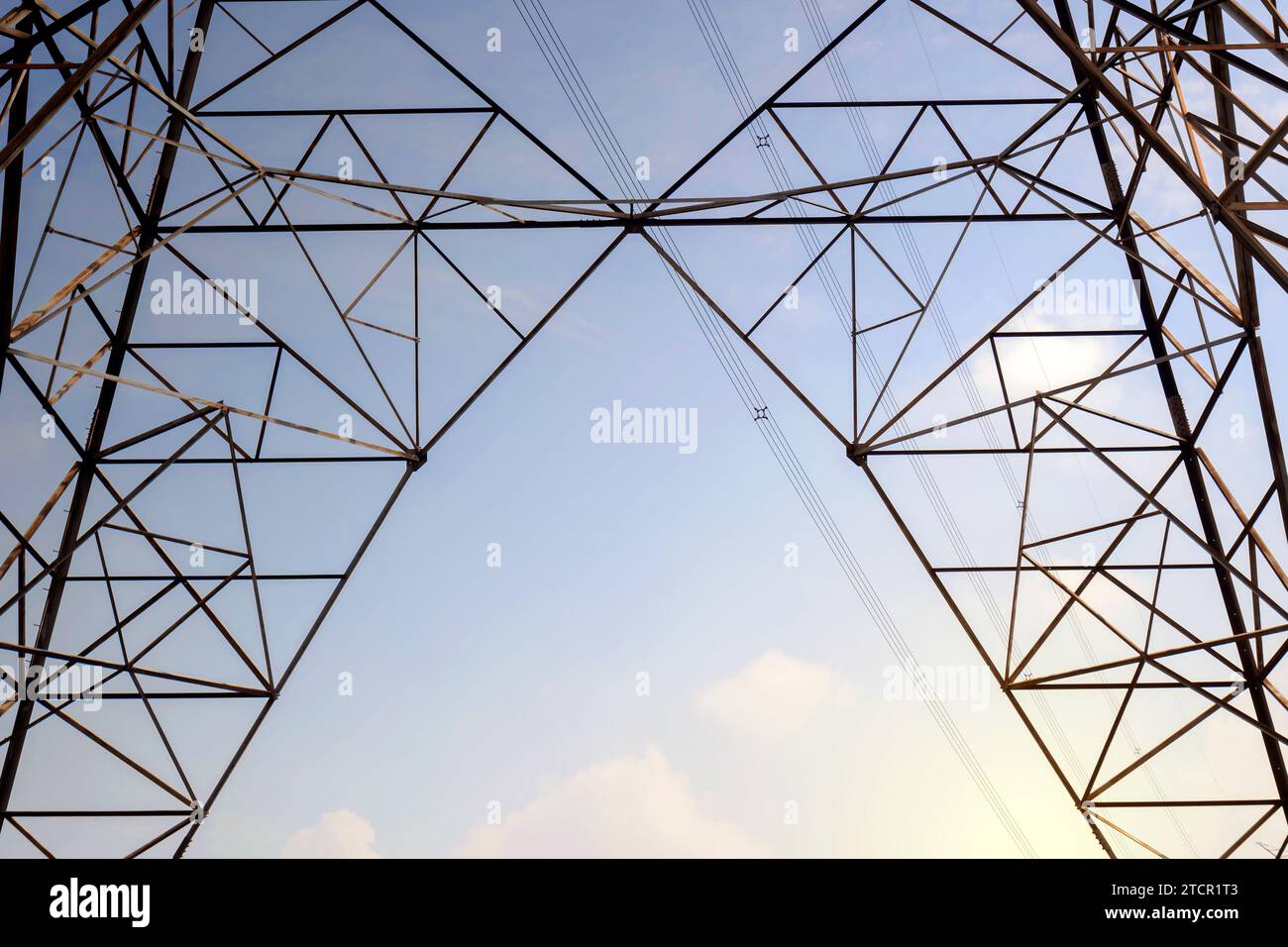 High voltage power lines tower with a sunset scene background Stock ...