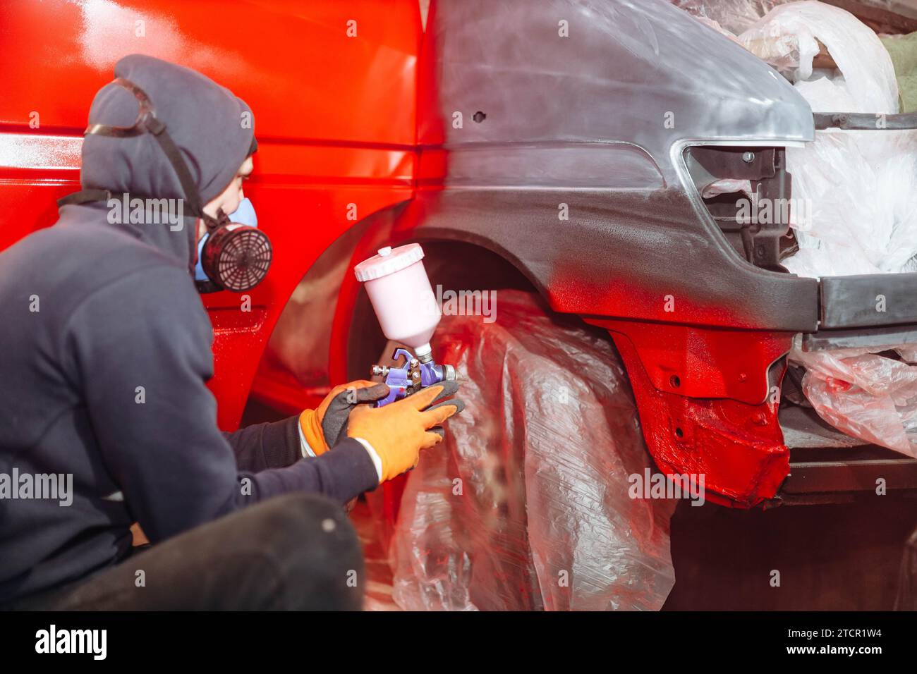 Spray painting a van car red. Restoration and body repair of cars Stock ...