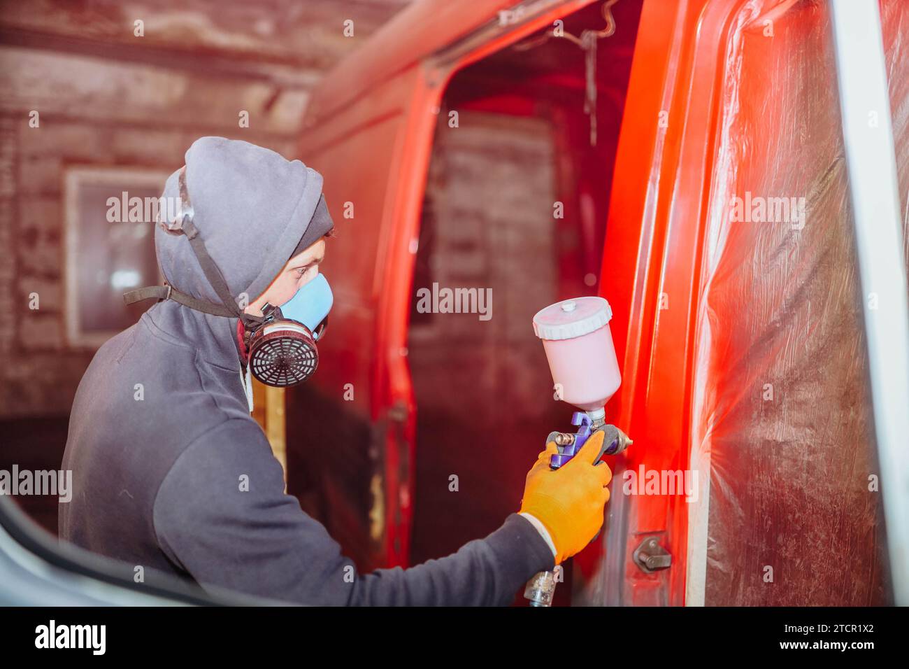 Spray painting a van car red. Restoration and body repair of cars Stock ...