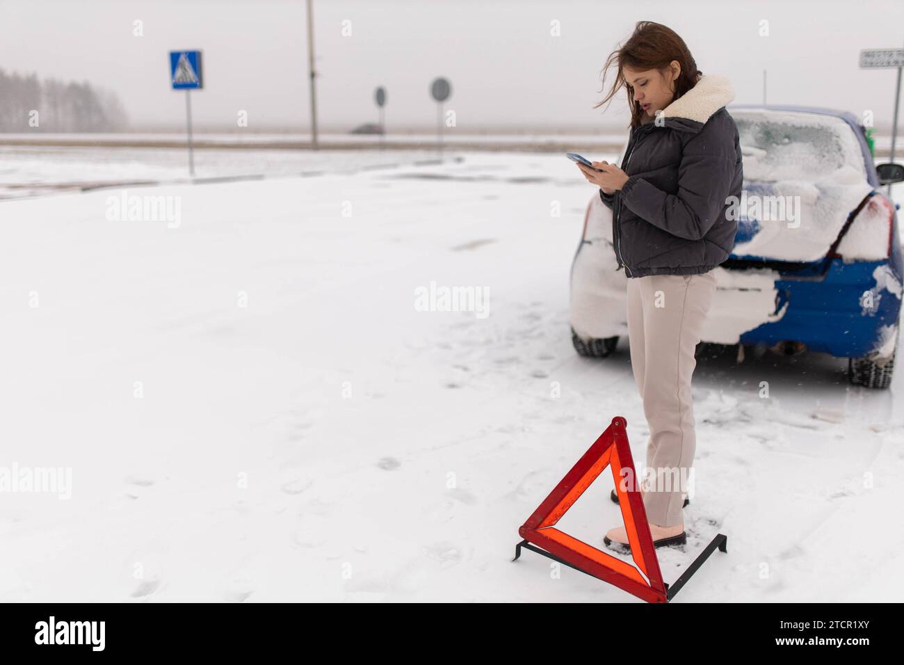 Young female driver who crashed her car on a slippery winter road in ...