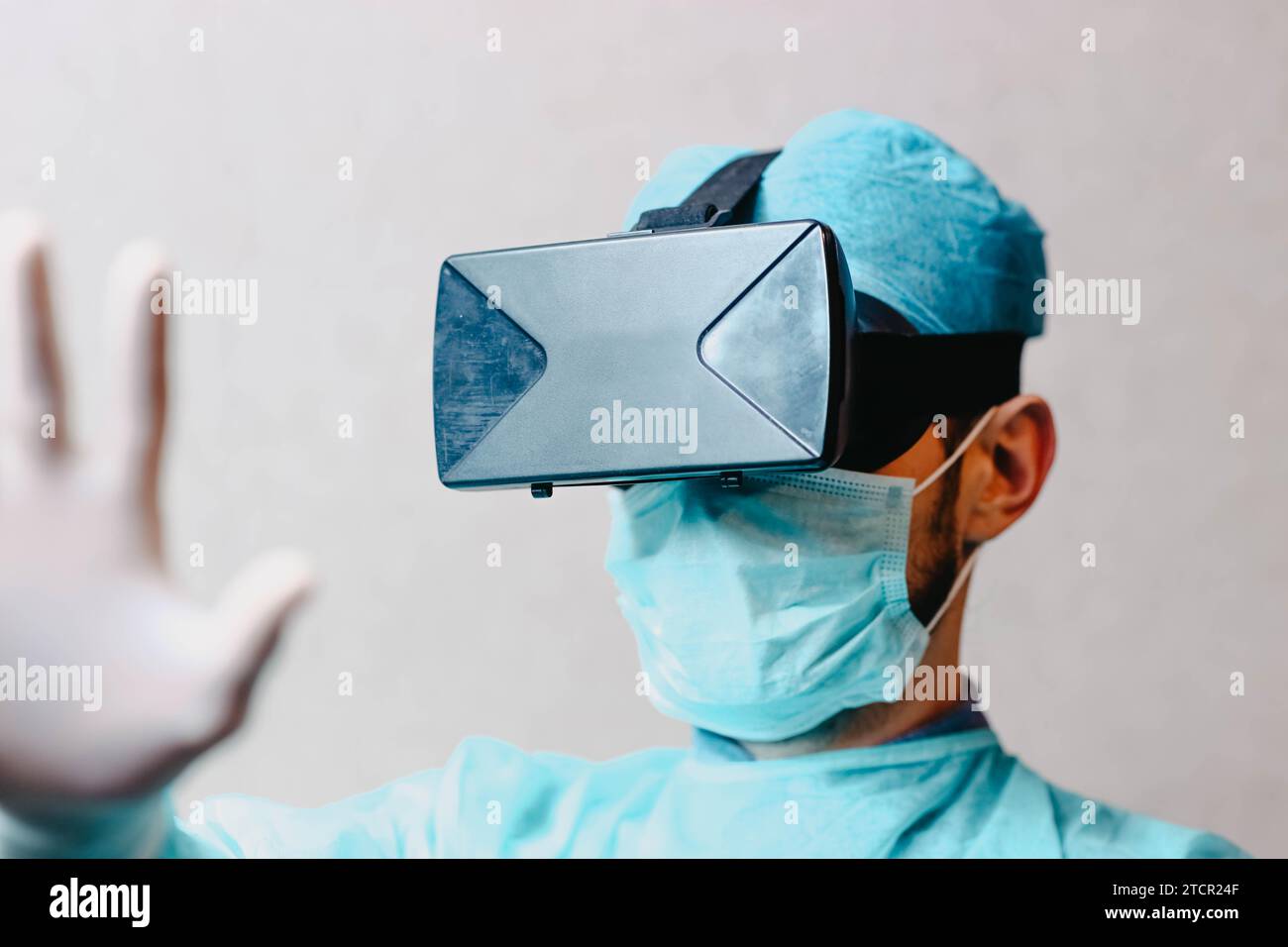 Male doctor surgeon in uniform and VR glasses helmet, the use of ...