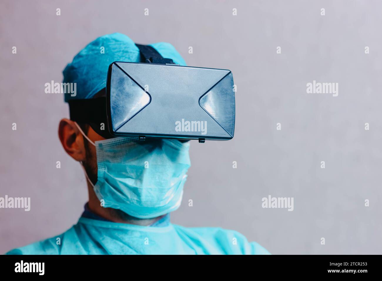Male doctor surgeon in uniform and VR glasses helmet, the use of ...