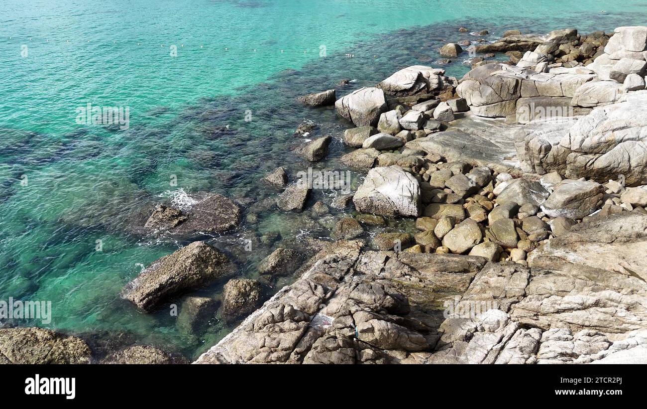 A tranquil scene of turquoise waters of the sea and rocky shore Stock ...