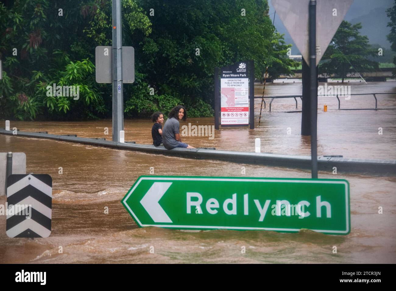Cairns, Australia. 14th Dec, 2023. Children walk through flood waters ...