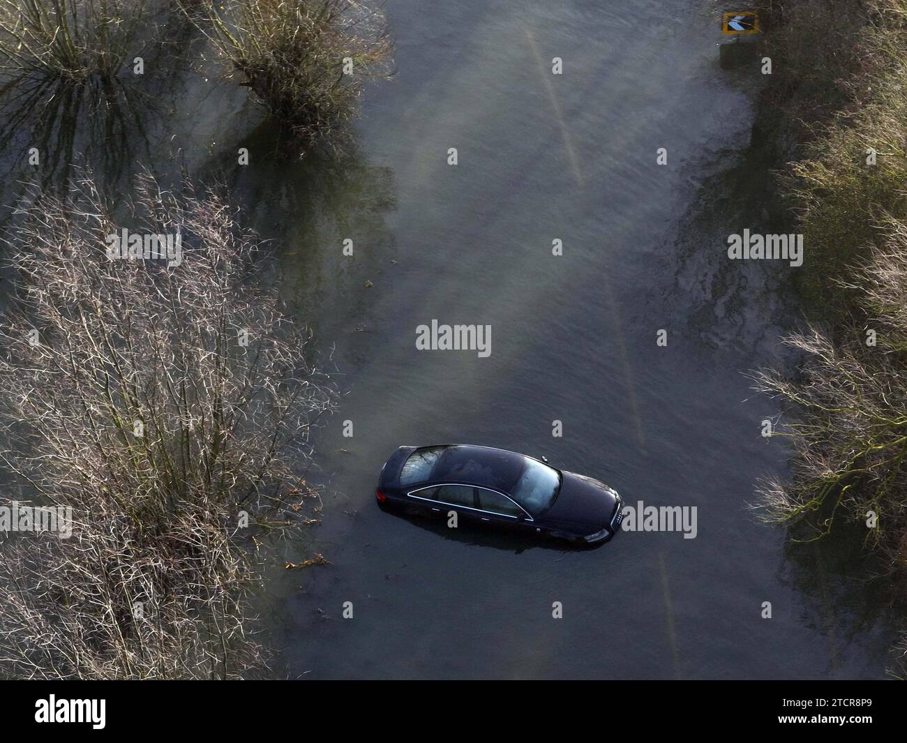 Welney, UK. 12th Dec, 2023. A stranded car in floodwater as the levels ...