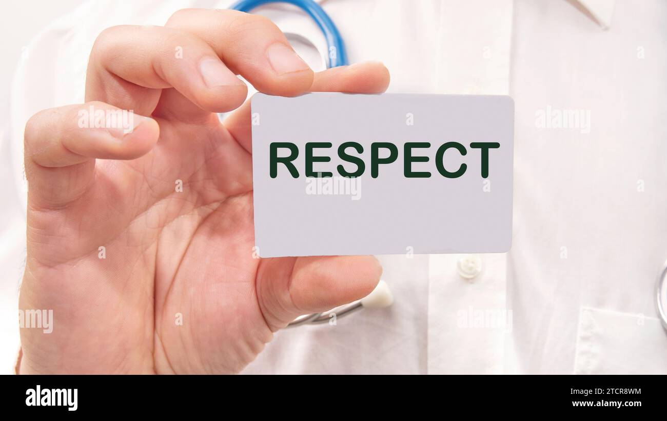 respect word on the card in a man's hand on the background of a white ...