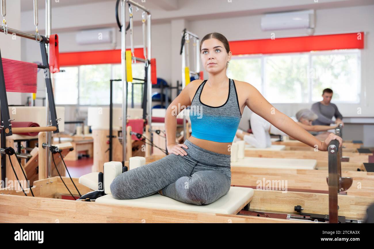 Girl performs exercise on reformer to improve coordination, balance ...