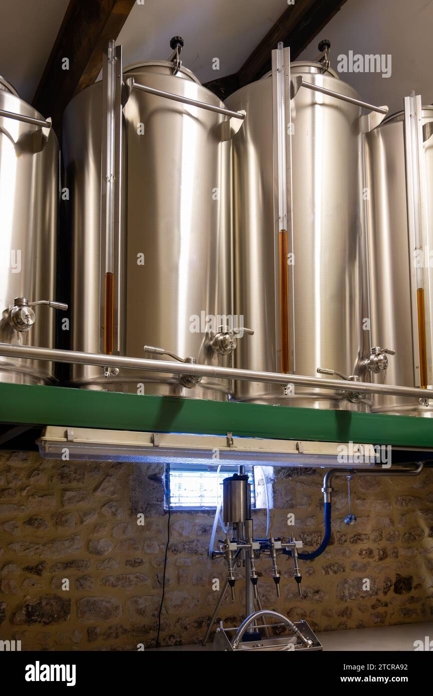 Blending process of cognac spirit and old dark French oak barrels in ...