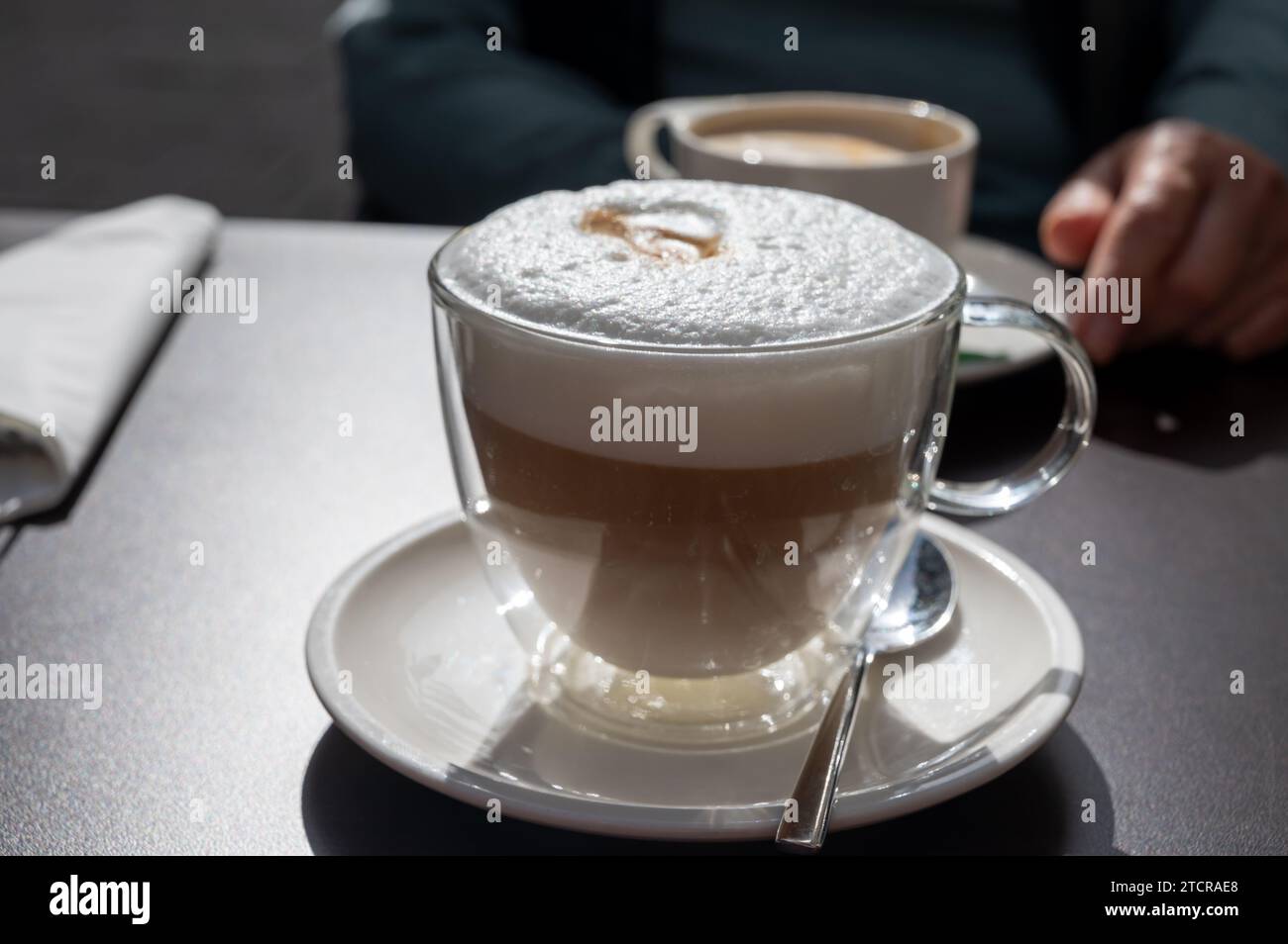Drinking of tasty fresh brewed Italian caffe latte coffee with whipped ...