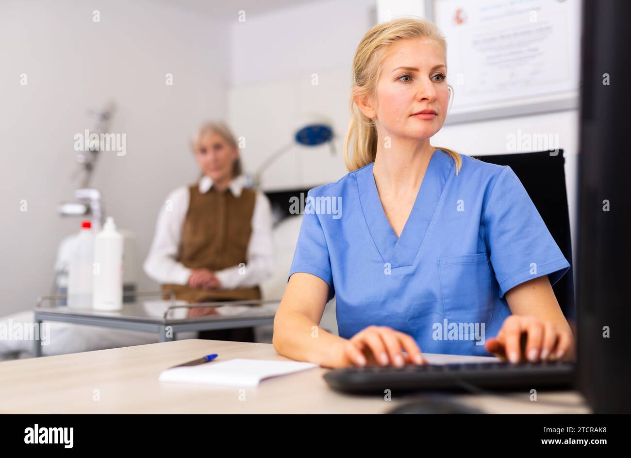 Young woman dermatologist using computer during appointment Stock Photo ...