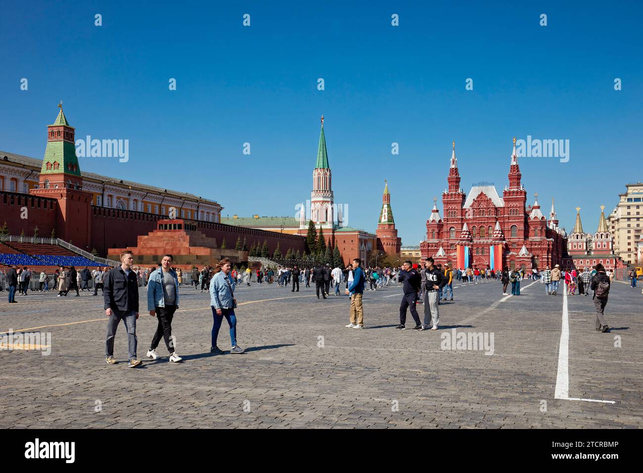 Red square people walking hi-res stock photography and images - Alamy