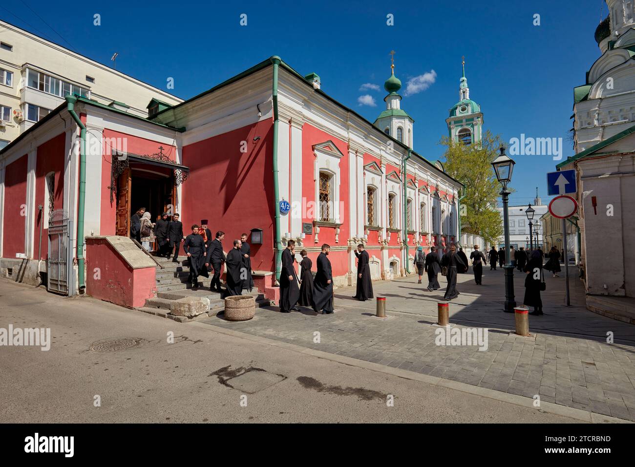 People dressed in Orthodox black robes walk out of the Church of The ...