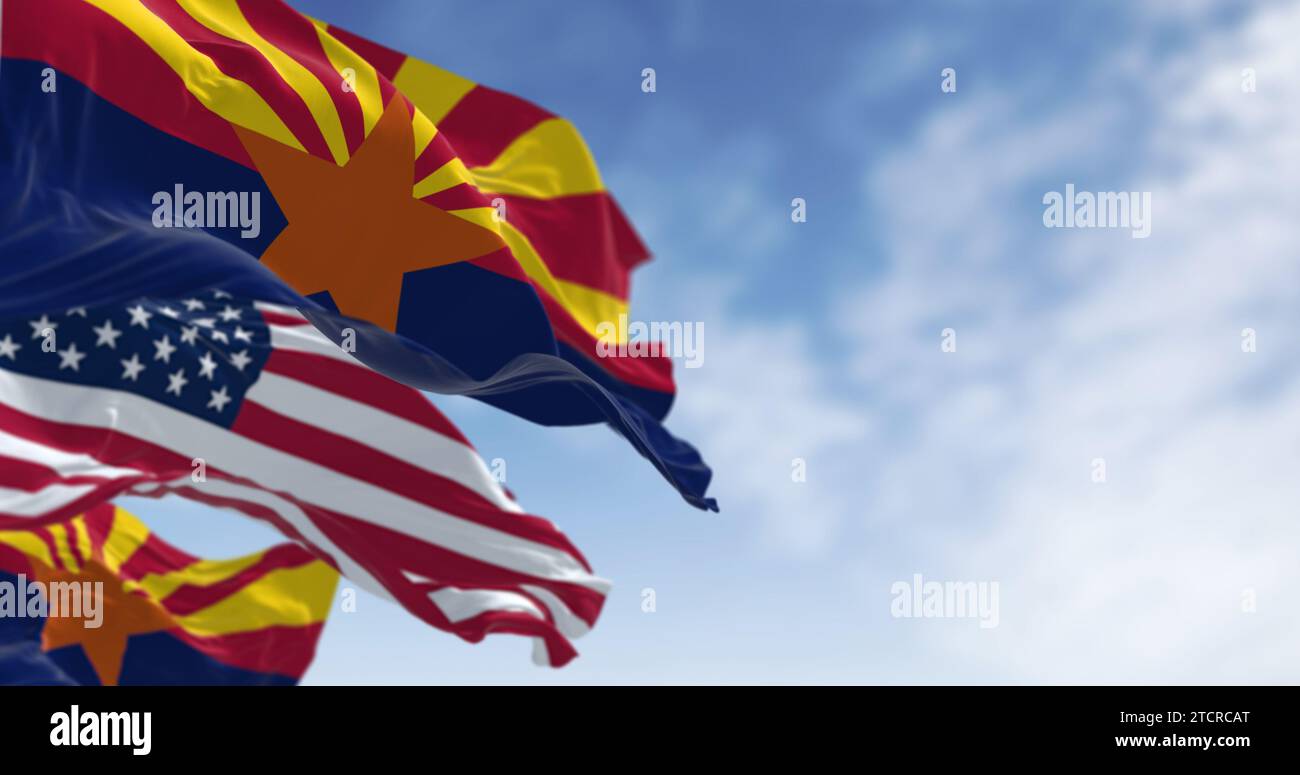 Flags of Arizona and United States waving in the wind on a clear day ...