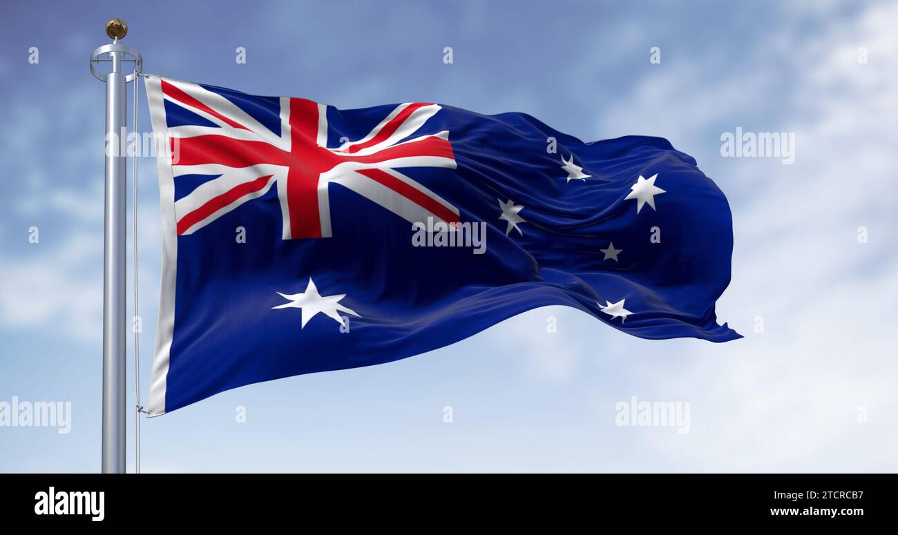 Three Australia national flags waving in the wind on a clear day. Blue ...
