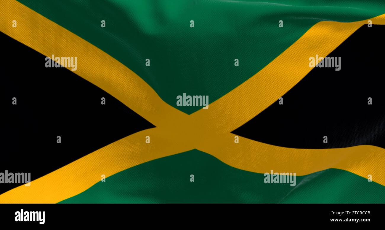 Close-up of Jamaica national flag waving. Gold saltire dividing it into ...