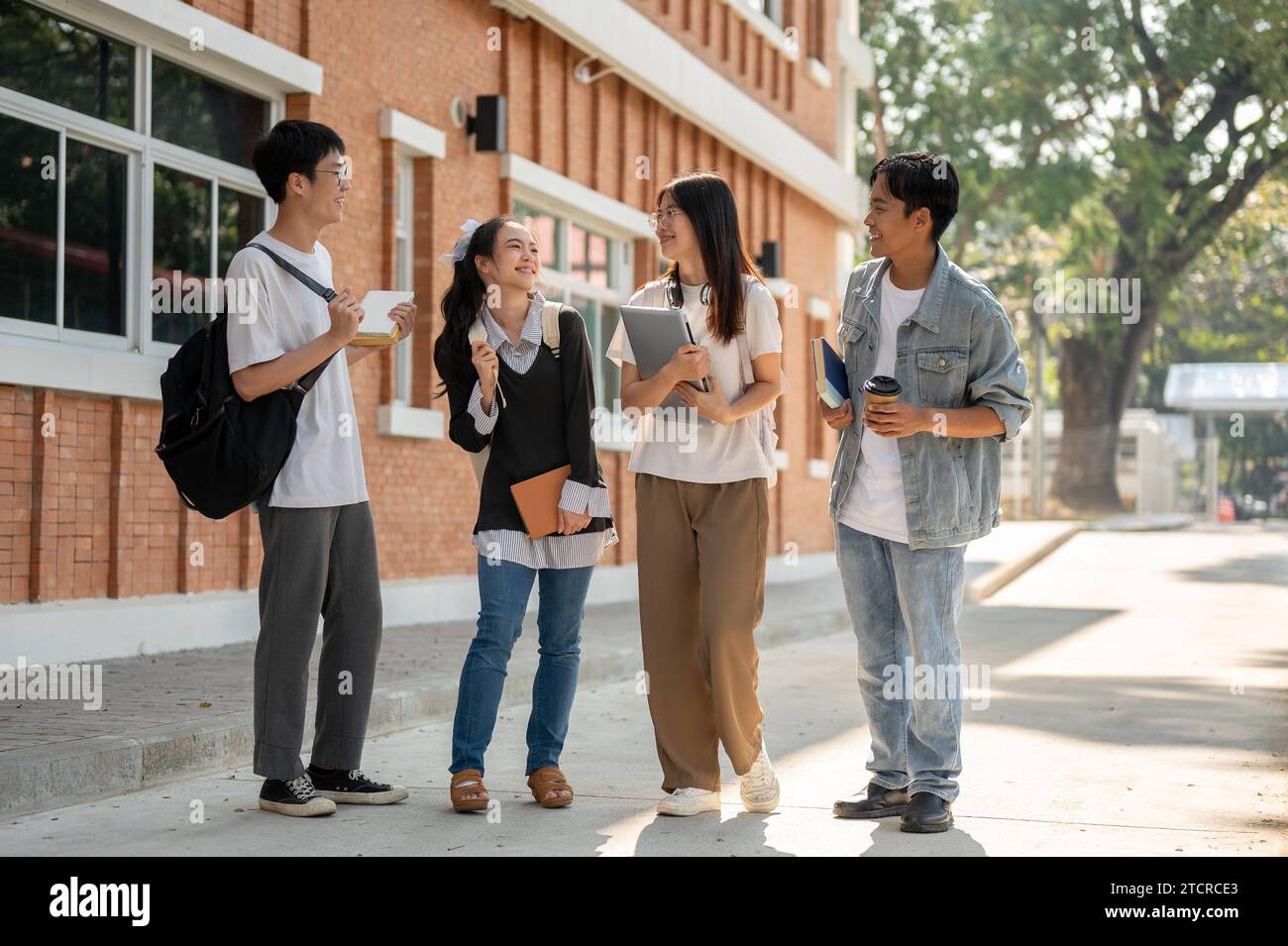 Group of diverse happy Asian college students are enjoying talking, sharing ideas, chatting ...