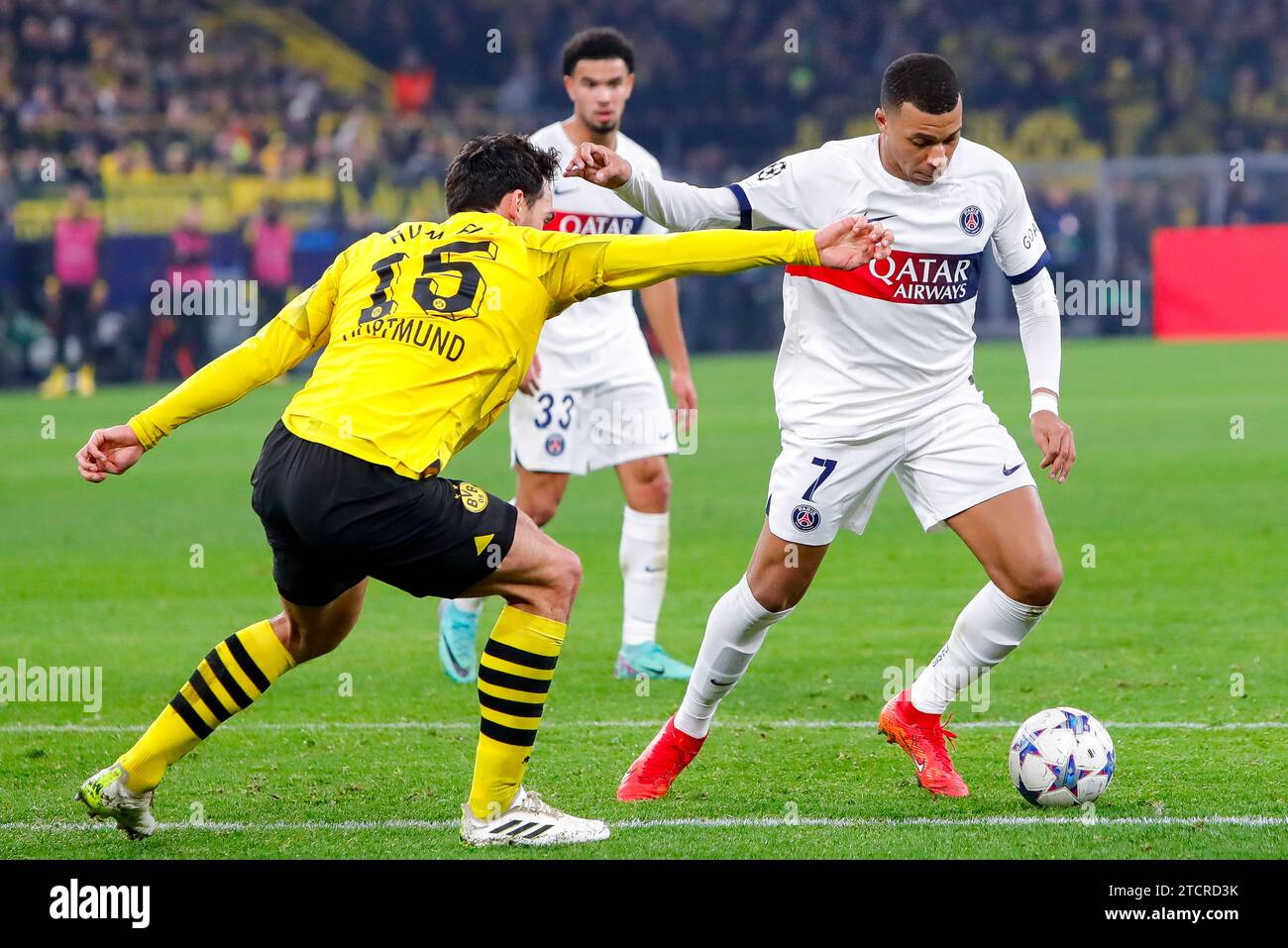 DORTMUND, GERMANY - DECEMBER 13: Mats Hummels (Borussia Dortmund) and Kylian Mbappe (Paris Saint ...
