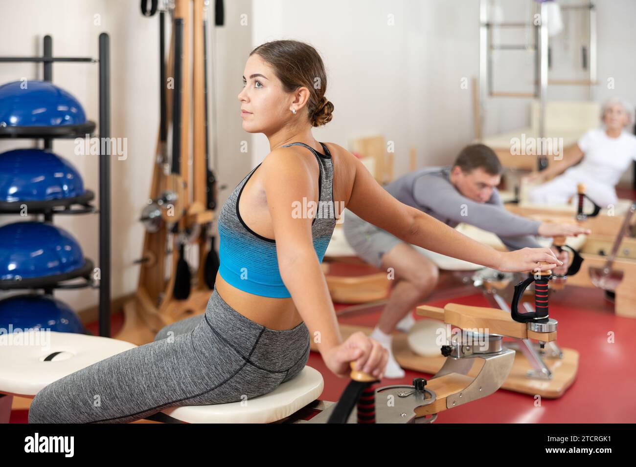 Girl performs Pilates exercises for weight loss and toning muscles of ...