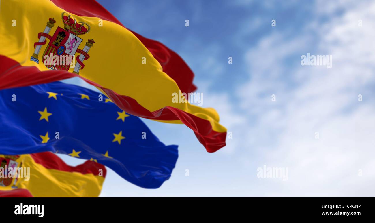 National flags of Spain waving with the European Union flag on a clear ...