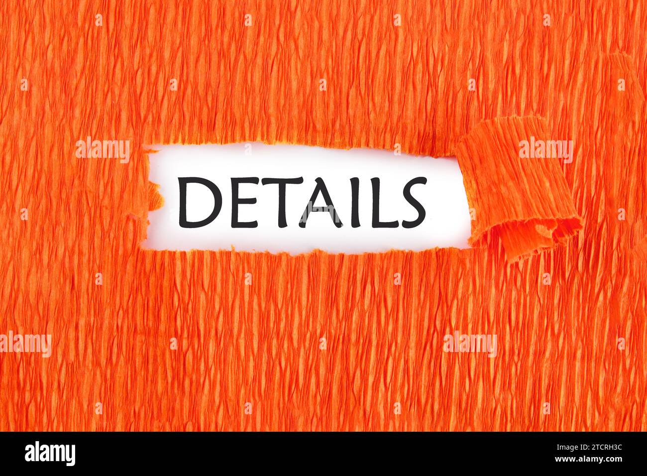 DETAILS the text under the torn paper is orange on a white background ...
