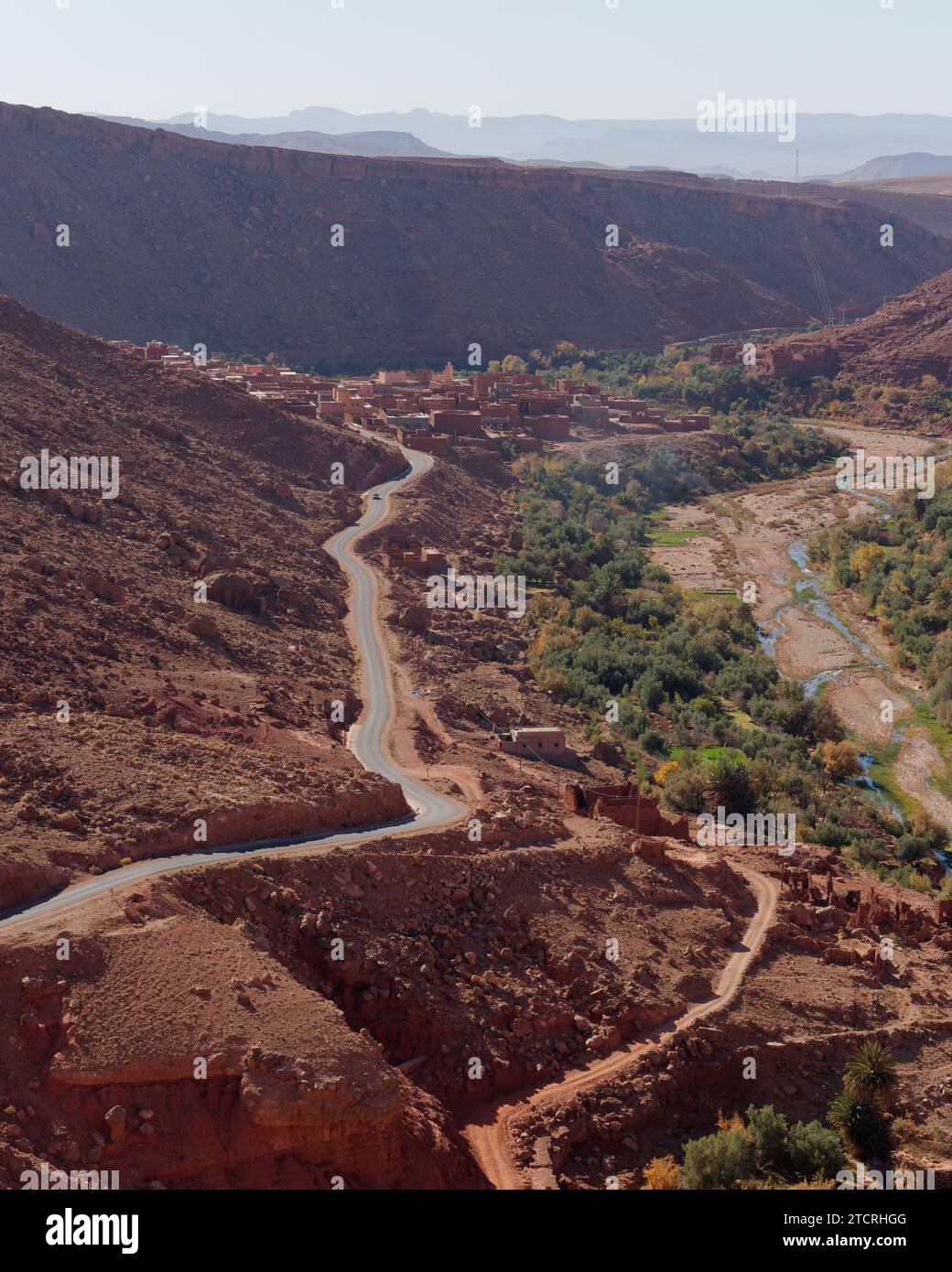 Elevated view over a winding road and traditional earthen village near ...