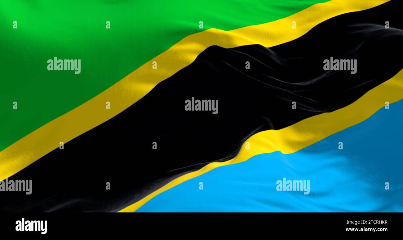 Close-up view of the Tanzania national flag waving. Green and blue ...