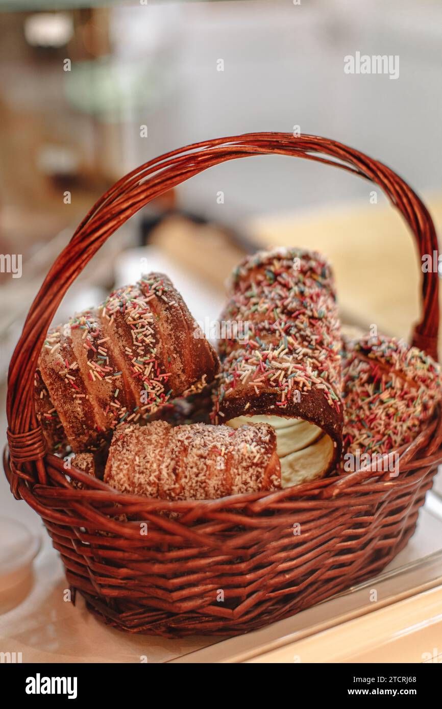 Sweet bread rolls with topping in a wicker basket Stock Photo - Alamy