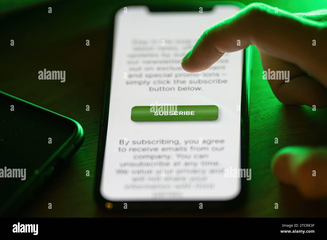 Clicking on green subscribe button on smartphone app Stock Photo - Alamy
