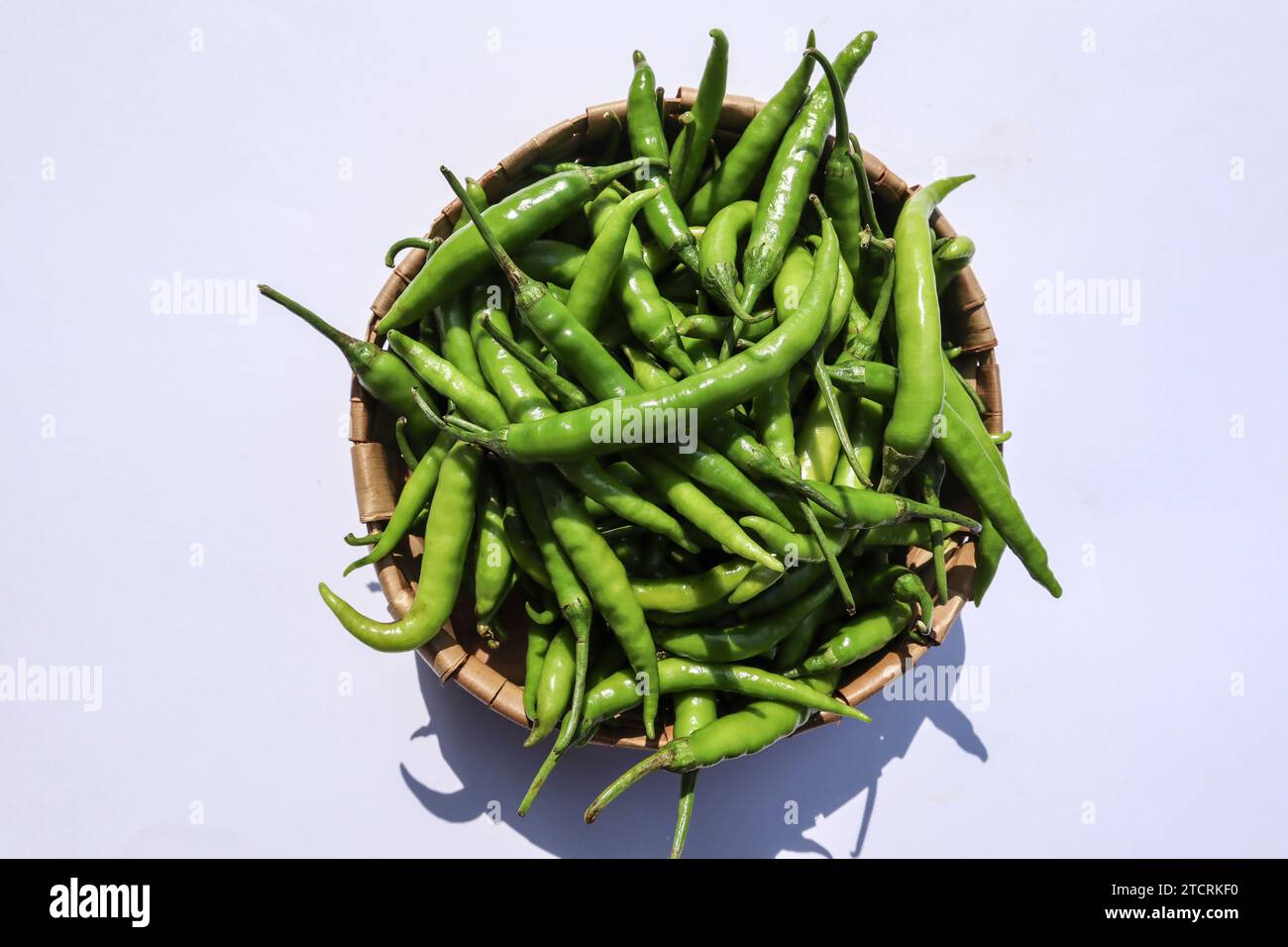 Fresh green chilly heap on white background Stock Photo - Alamy