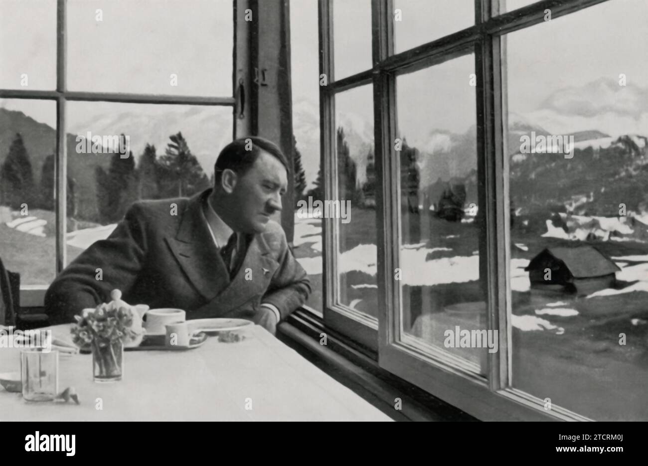 Adolf Hitler is captured sitting at a dining table in the G'schwandner ...