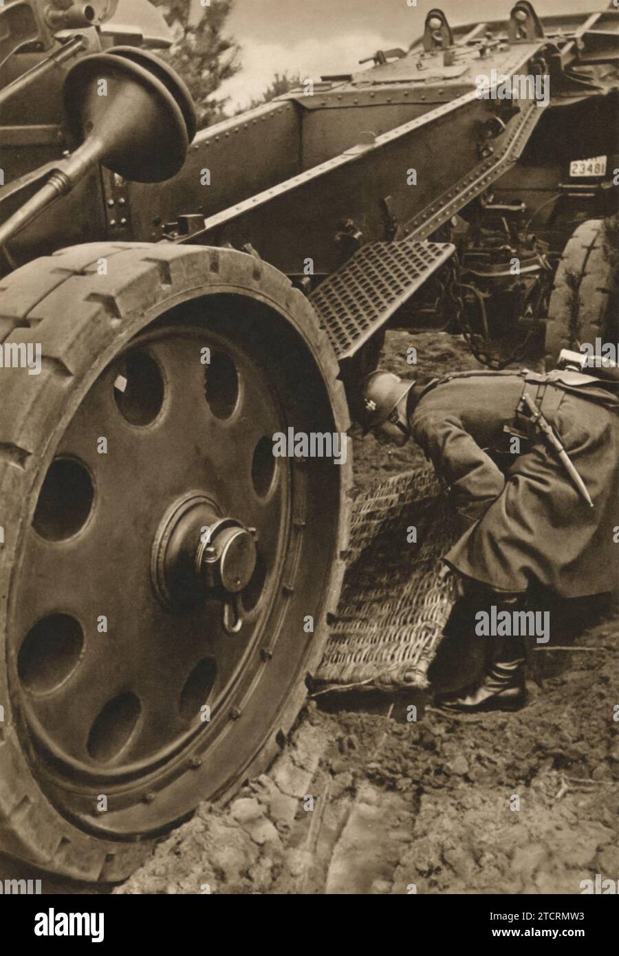 A German soldier employs woven mats under a howitzer's wheels to ...