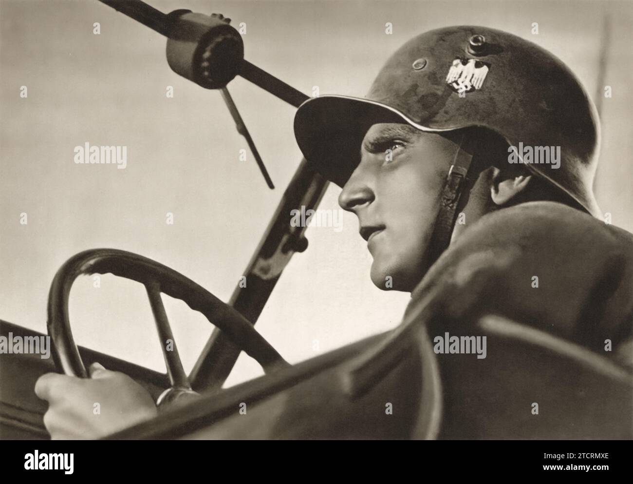 A German soldier is seated in the driver's seat of a standard offroad ...