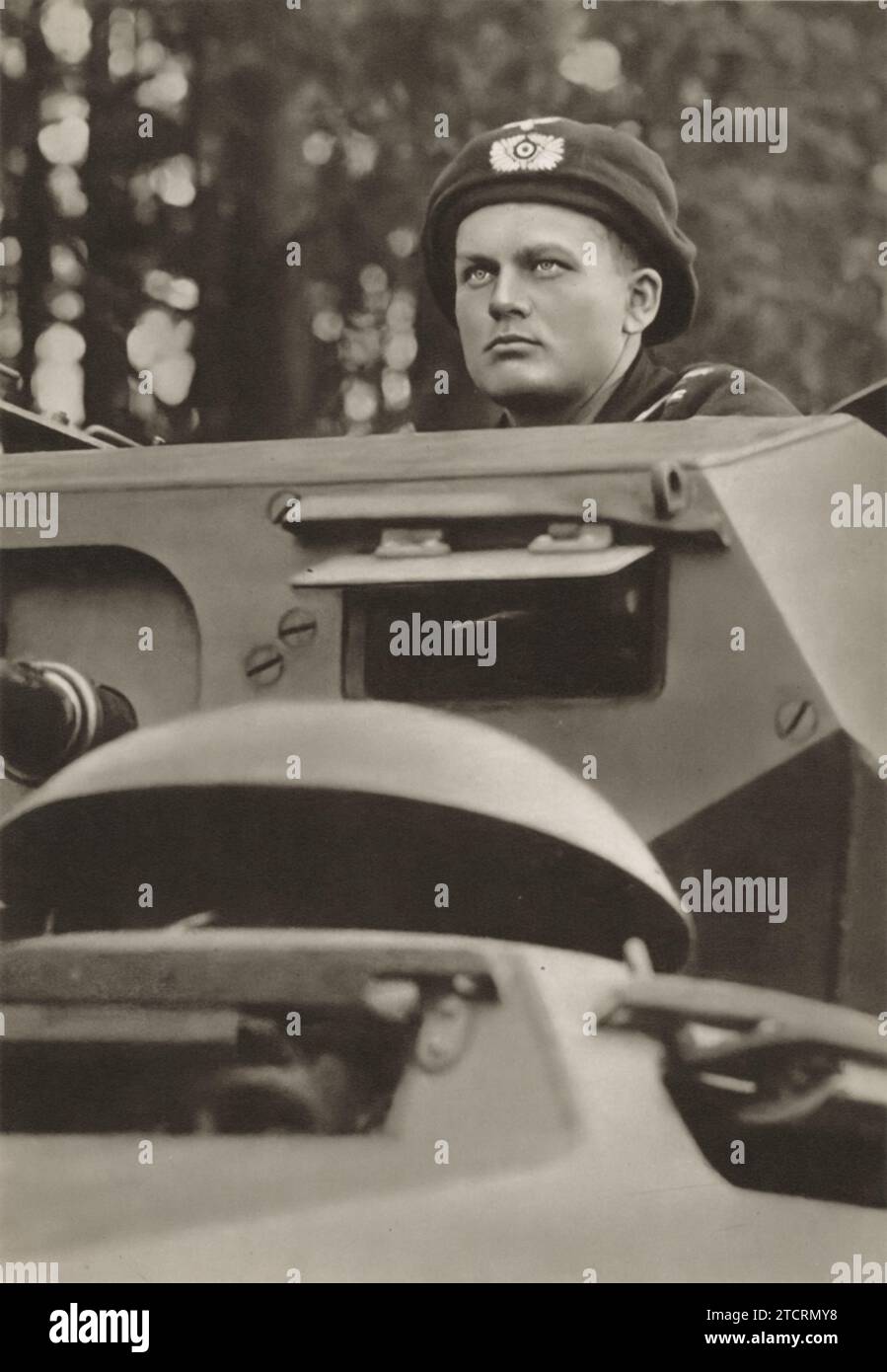 A German soldier, pictured inside a heavily armored vehicle, holds a ...
