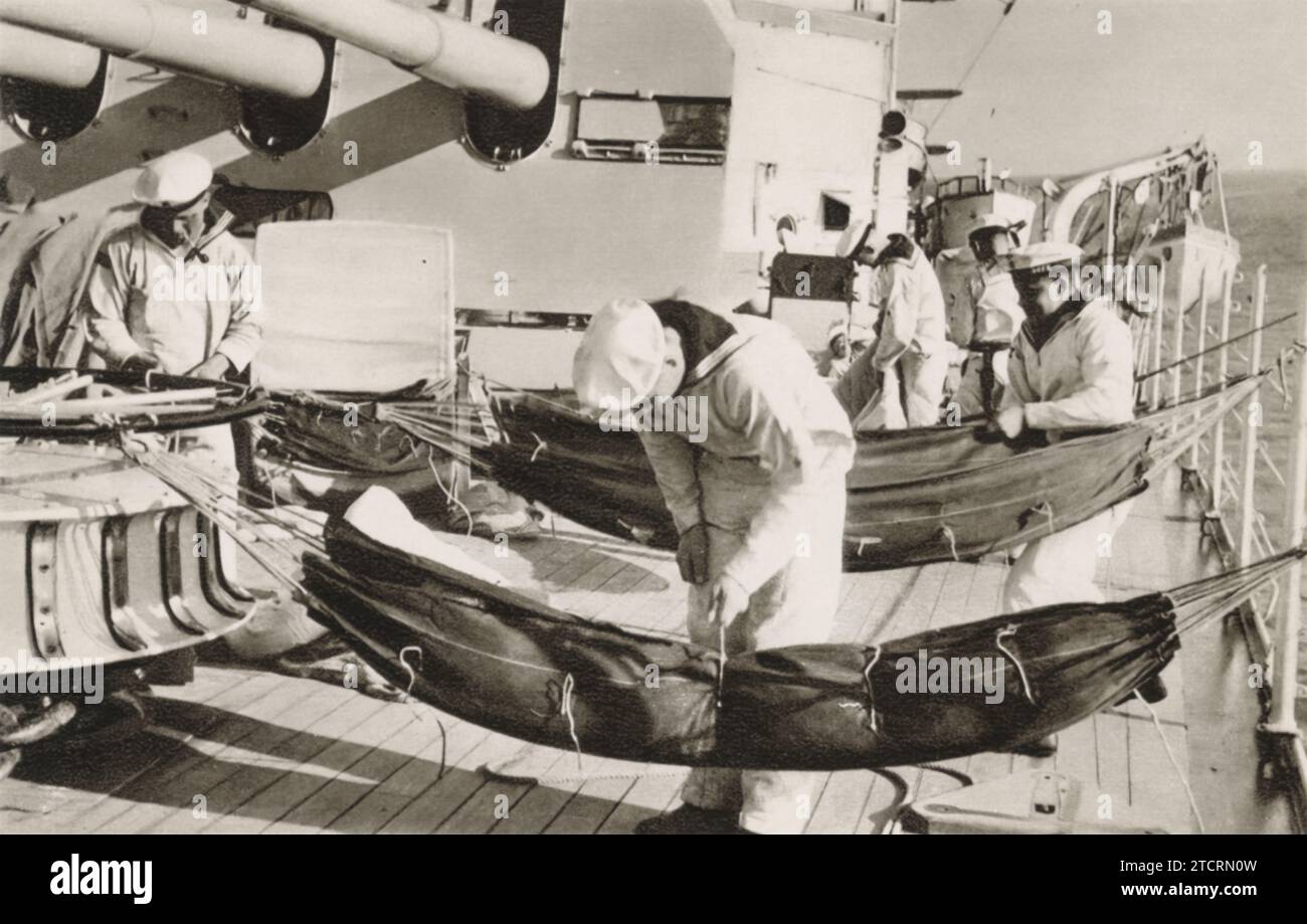In this image, German Marines from the Kriegsmarine are seen hanging ...