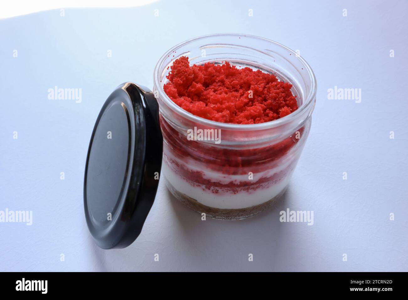 Red velvet Jar cake with open lid isolated on white background Stock ...