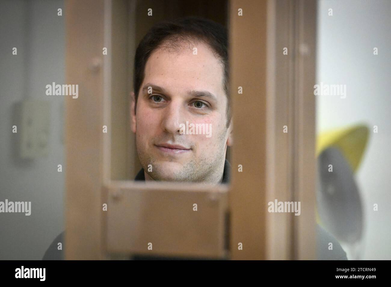 Wall Street Journal Reporter Evan Gershkovich Stands In A Glass Cage In