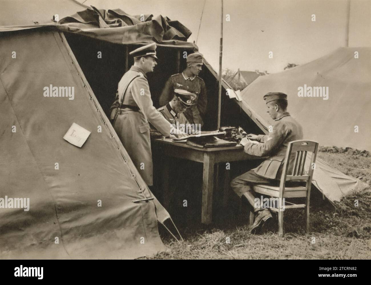 A German command staff is deeply engaged in their duties, illustrating ...