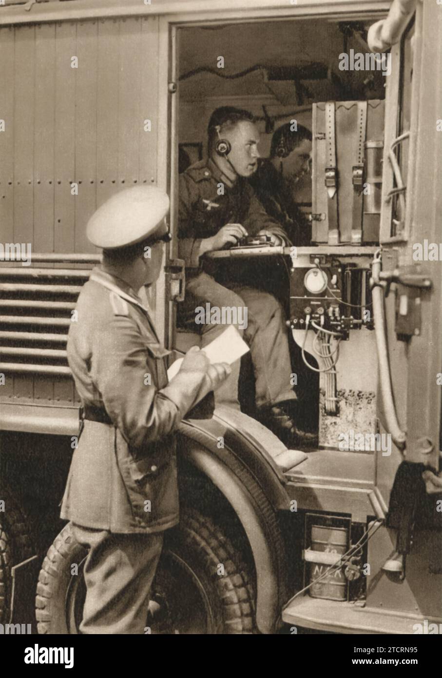 A German officer is shown relaying information to the communications ...