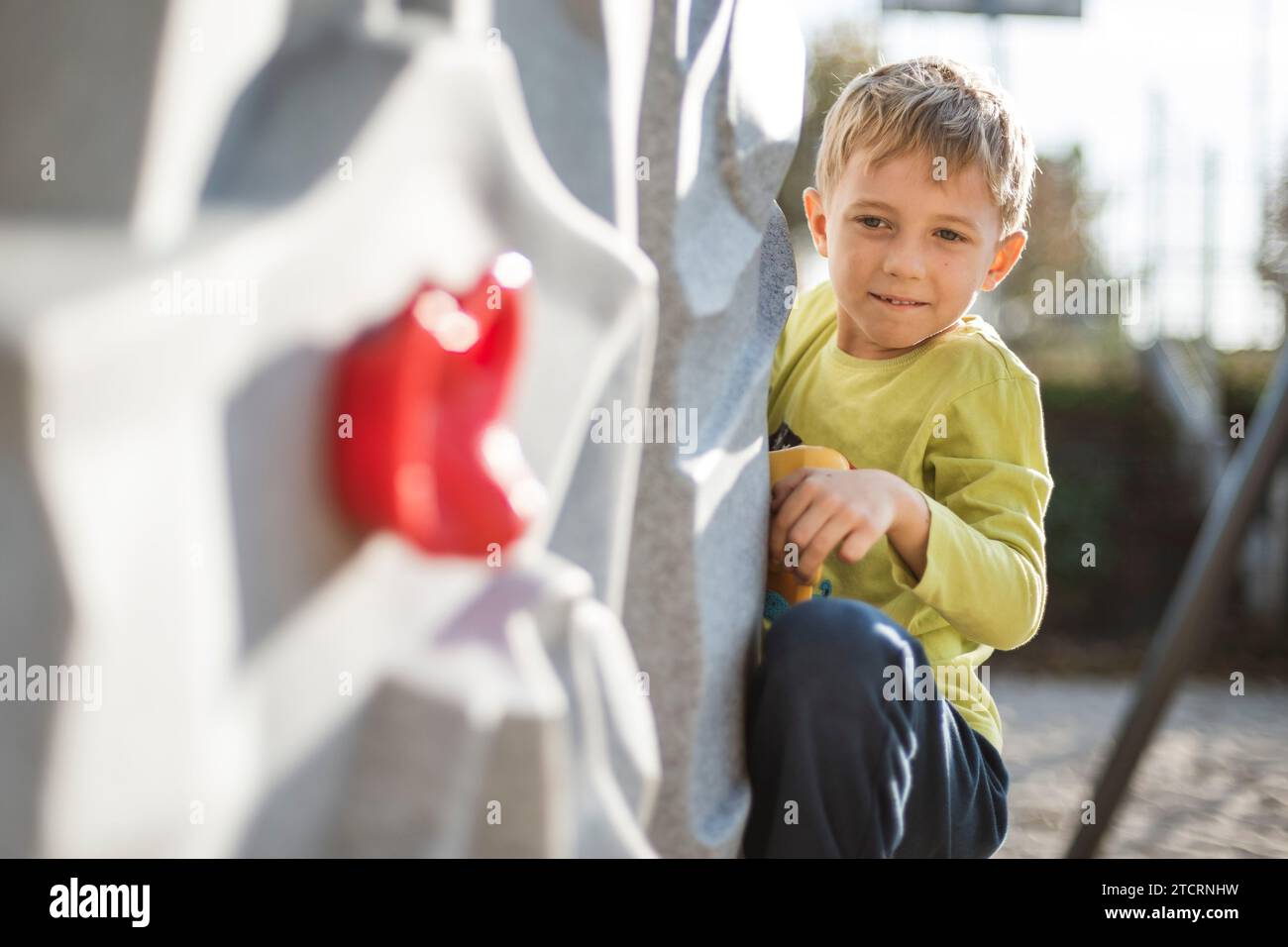 Seven year old boy climbing at artificial wall Stock Photo - Alamy