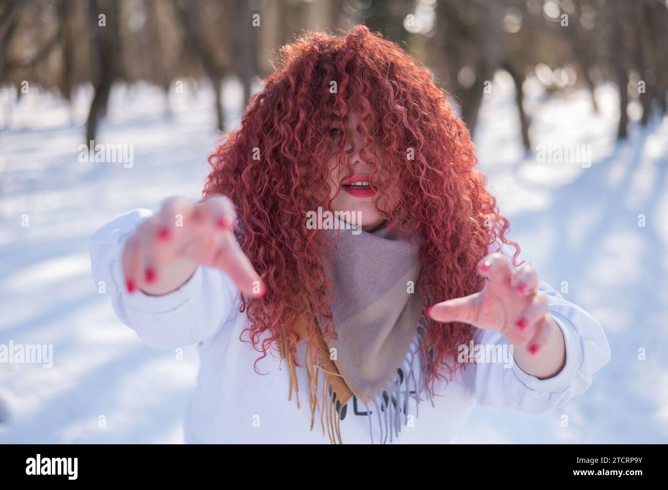 The plump-cheeked woman threw her red hair over her face and held out ...